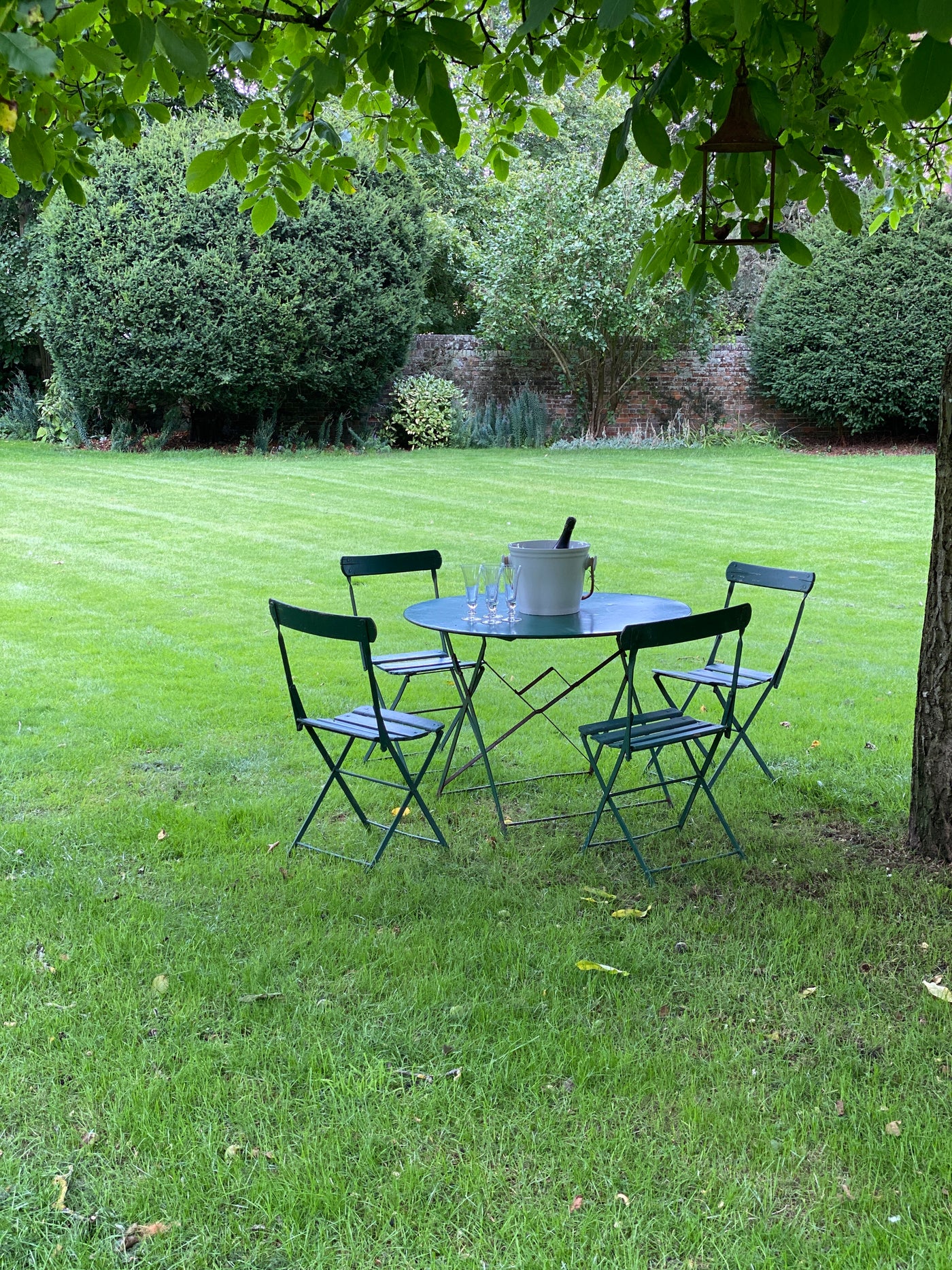 Vintage green bistro table with wooden chairs